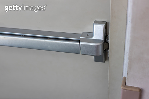 Emergency fire exit door. Closed up latch and rusty door handle of ...