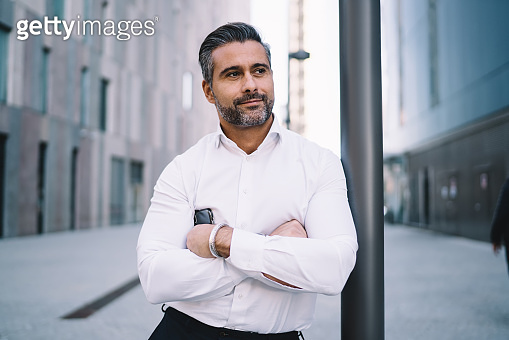 Caucasian male banker with crossed hands standing at urbanity in ...
