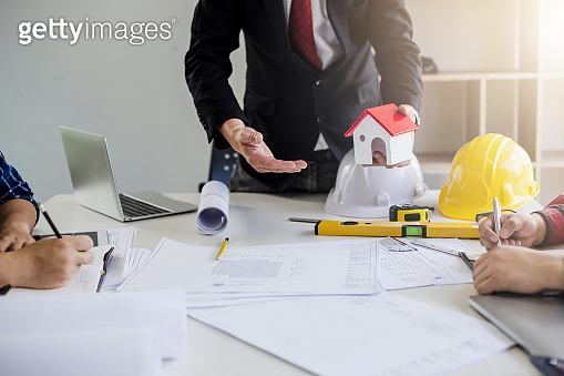 Businessman, construction project owner and engineer planning and ...