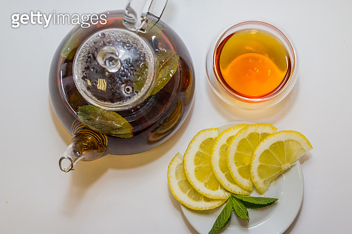 Ice tea with lemon splash. Hot yellow tea with lemon and many slices of ...