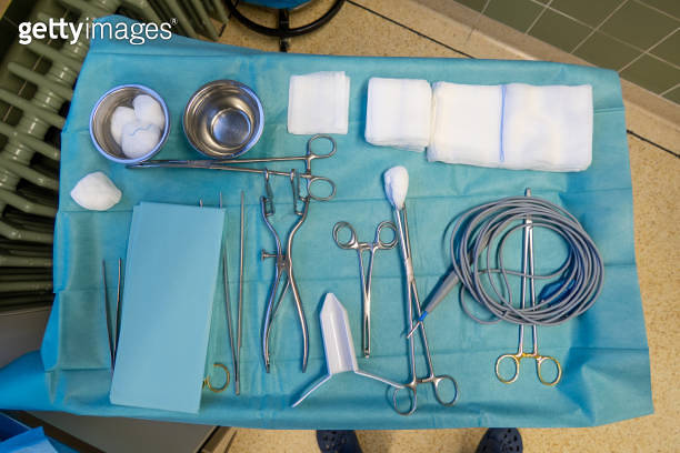 on operating table lie the instruments for a proctoscopic procedure ...