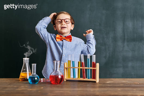 Cute child scientist learning science at classroom with chemistry tools ...