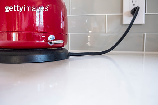 Red Electric Kettle Is Plugged In and Turned On to Boil Water ...