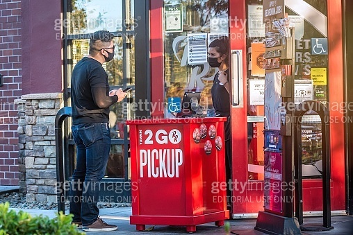 Red Robin Restaurant employee attending client coming to pick up food ...