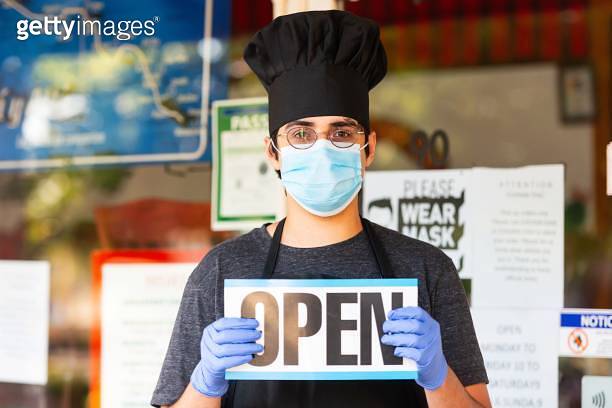 Chef fast food restaurant owner posing wearing a mask holding an Open ...