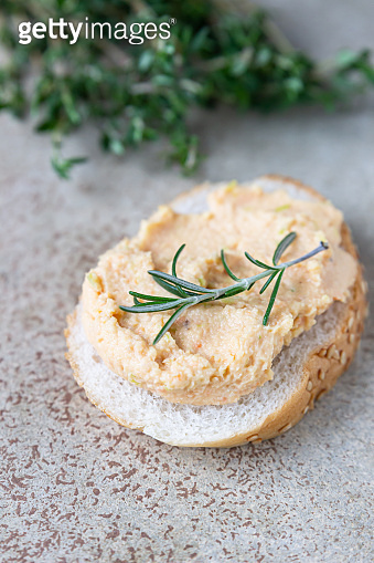Homemade pate, spread or mousse on bread and herbs, light concrete ...