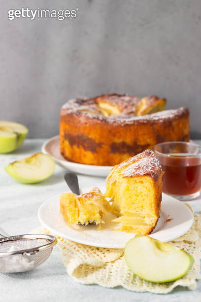 Piece of charlotte with apples. Delicious apple pie or sponge cake ...