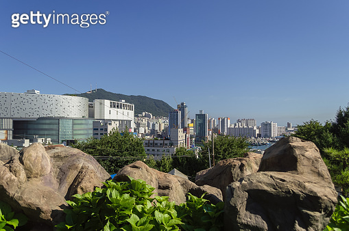 view on a cityscape of Busan from park with decorative rocks as natural ...