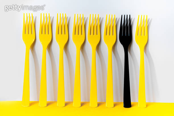 Six bright yellow plastic forks and one black fork, kitchen art ...