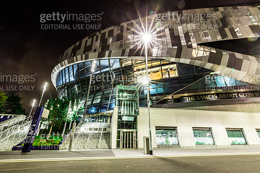 Exterior of new Tottenham Hotspur stadium illuminated at night in ...