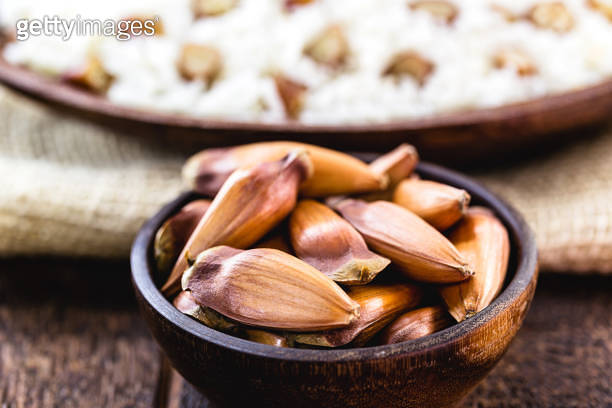 pine nut seed seen from above, shelled and cooked, ready to be used as ...