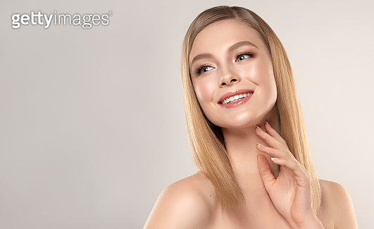Portrait of beautiful blonde haired model with wide tender smile on the ...