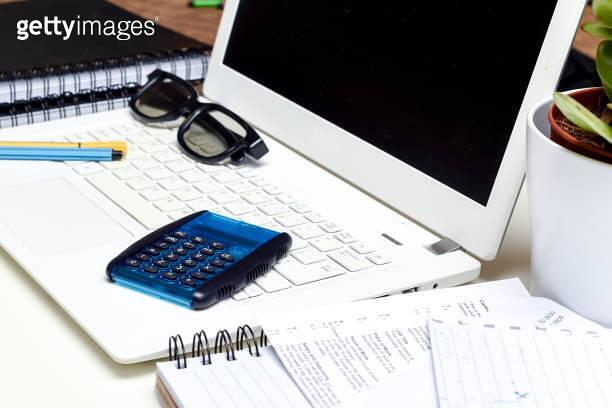 Calculating tax return numbers and figures on office desk concept for ...