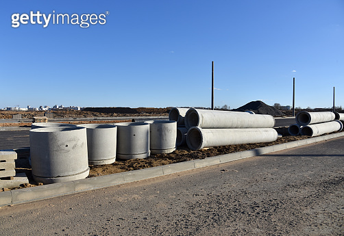 Concrete drainage pipes at the construction site. Laying of underground ...