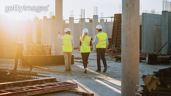 Diverse Team of Specialists Taking a Walk Through Construction Site ...