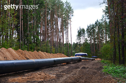 Natural gas pipeline construction work. A dug trench in the ground for ...