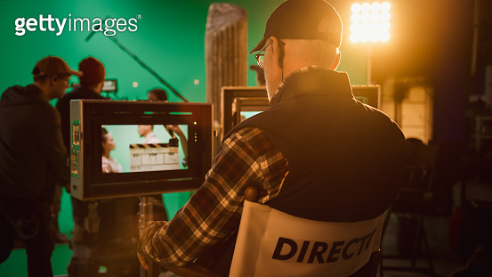 Director Looks at Display Controls Shooting History Movie. Green Screen ...