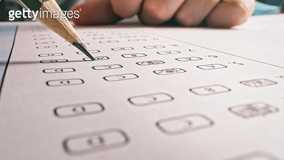 On Exam Test Person Colors Right Answers with a Pencil. Filling up ...