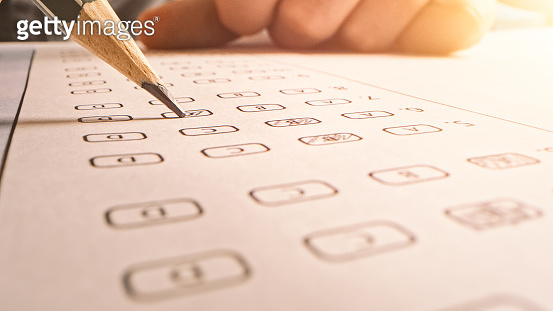 On Exam Test Person Colors Right Answers with a Pencil. Filling up ...