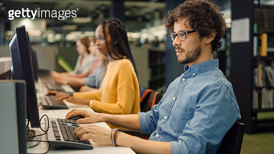 University Library: Handsome Bright Boy using Computer for Class ...