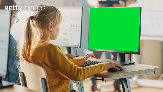 Elementary School Computer Science Classroom: Cute Little Girl Uses ...