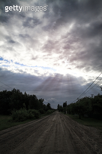 Beautiful, and epic thunderclouds in a village with a road to the ...