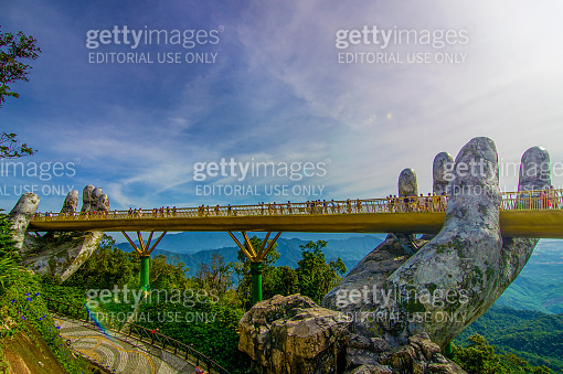 View of the Golden Bridge is lifted by two giant hands in the tourist ...