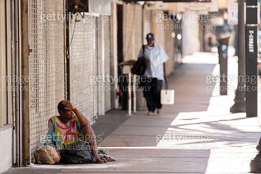 Homeless woman sitting on a sidewalk at Downtown Miami FL (1220876027 ...