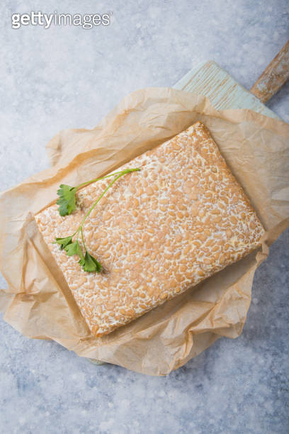 Slice of tempeh or tempe made of fermentation process that binds ...