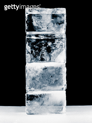 Stacked textured transparent frosted crystal clear ice blocks on black ...
