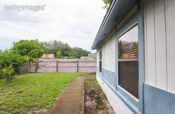 Windows of Residential Home Exterior Facing Fenced in Backyard ...