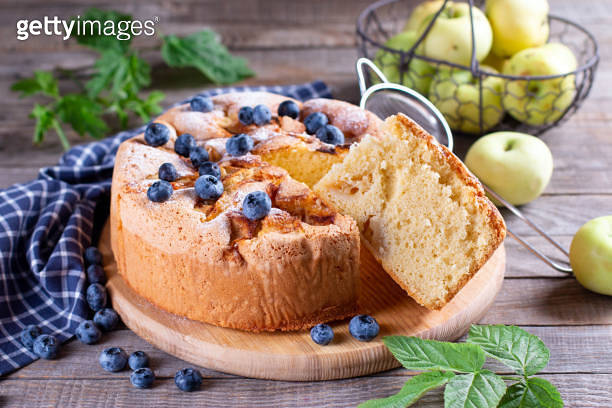 Apple pie, sponge cake, Charlotte with with apples and blueberries on a ...