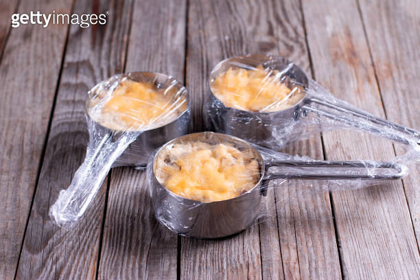 Mushroom, chicken and cheese gratin in bowls in cling film for further ...