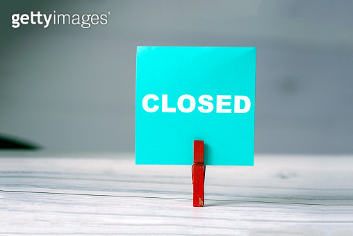 Reminder sticky note with clothes pin on table. Sticky note with ...