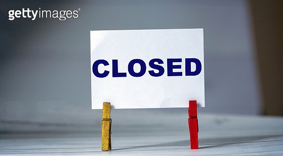 Reminder sticky note with clothes pin on table. Sticky note with ...