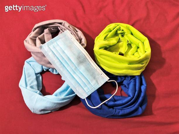 Disposable face mask lying across bandana cloth face masks 이미지 ...