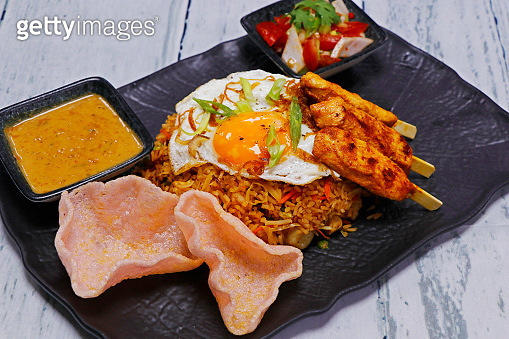 Nasi goreng, literally meaning fried rice in Indonesian, serve with ...