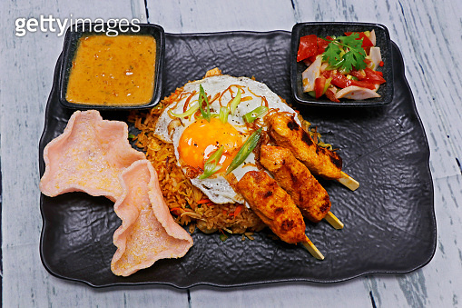 Nasi goreng, literally meaning fried rice in Indonesian, serve with ...