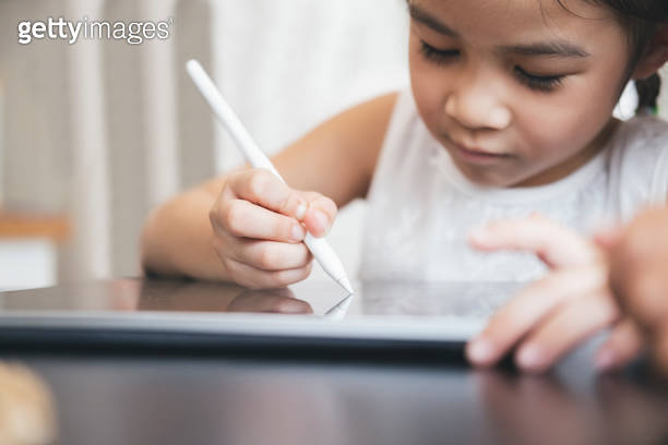 Little girl with tablet and stylus learning drawing online. Remote ...