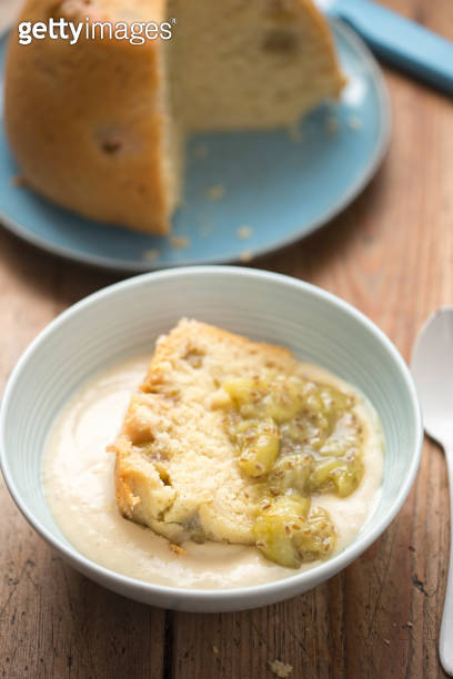 Cooked gooseberry summer pudding with vanilla custard and gooseberry ...