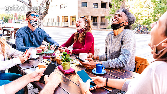 People having fun drinking latte outside at coffeehouse - Young friends ...