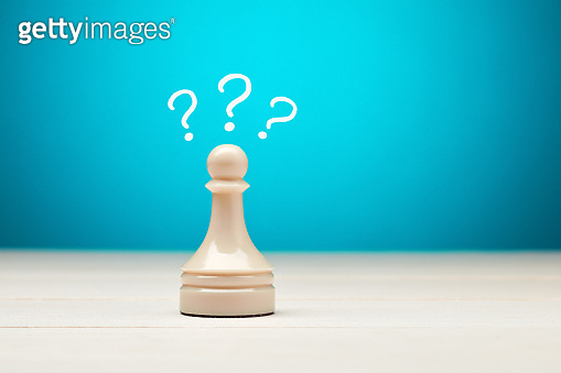 Pawn chess piece with question marks. Uncertainty, problem, confusion ...