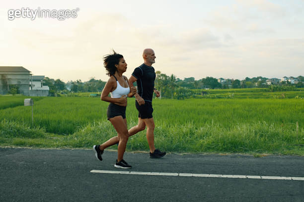 Mature Couple Running On Road At Tropical Landscape. Caucasian Man And ...