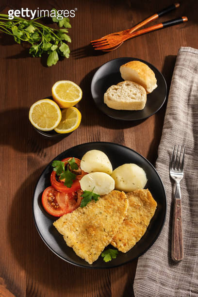Vertical top view of a delicious baked battered fish seasoned with ...