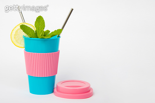 Reusable blue cup with pink silicone sleeve and lid, with metal straws ...