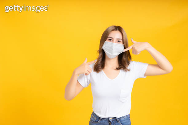 Asian women pointing finger and wear correct masks to protect against ...