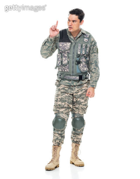 Caucasian male armed forces standing in front of white background in ...