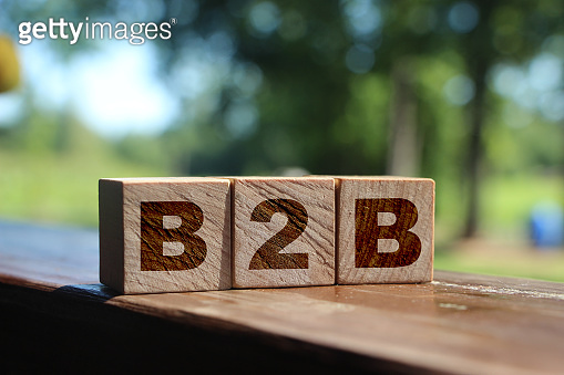 B2C on wooden cubes on wooden table outdoors. Summer nature . Business ...