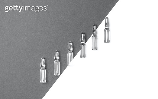 Line of ampules for injections on trendy grey and isolated white ...