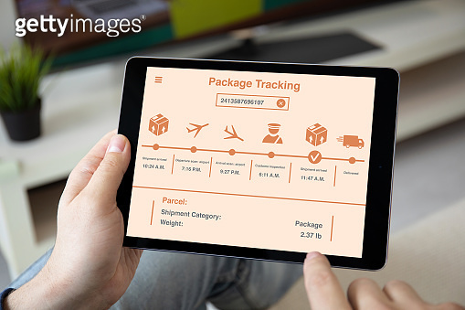 man hands holding computer tablet with app package tracking (1220734370 ...